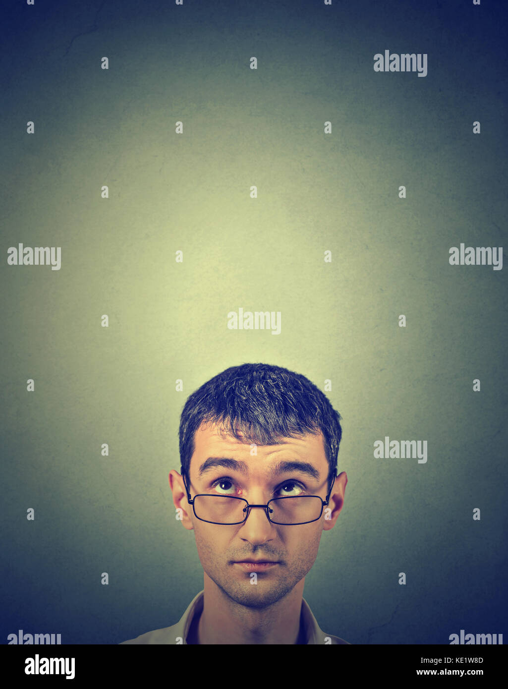 Closeup portrait pensive young man looking up Stock Photo - Alamy