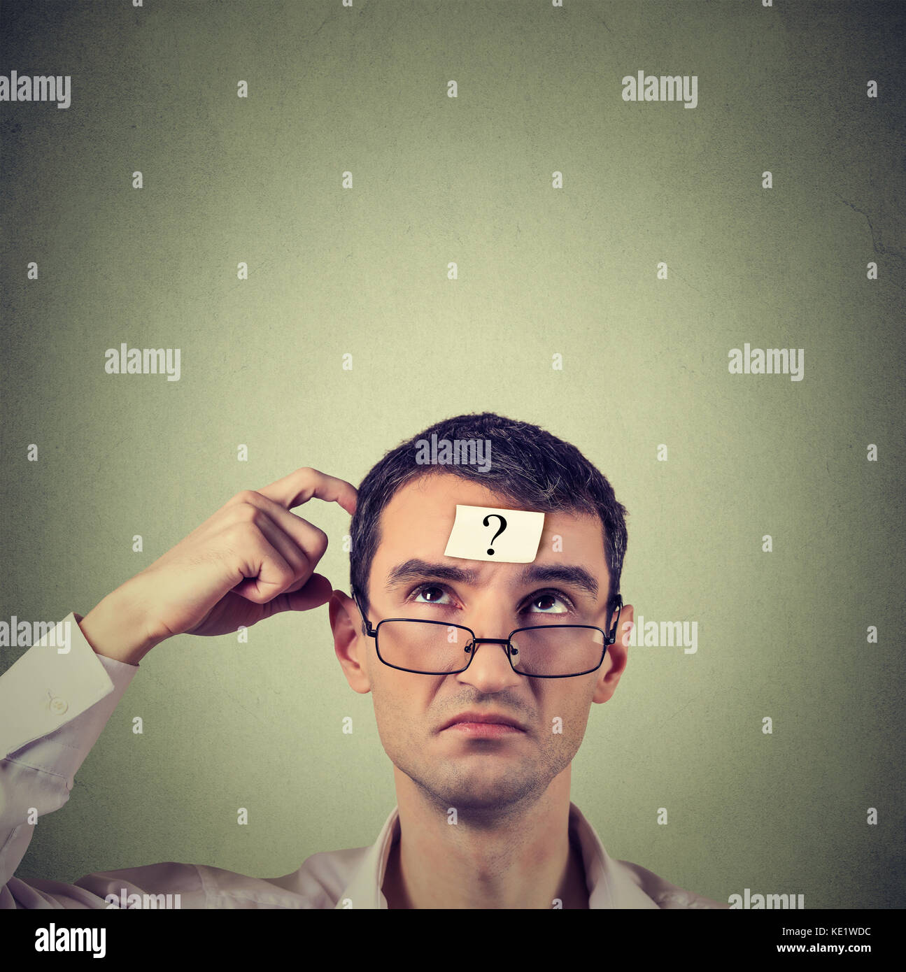 thinking man with question mark isolated on gray wall background Stock ...