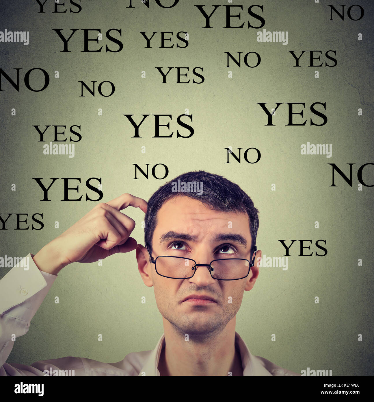 Headshot thinking perplexed young man in glasses with yes or no choice ...