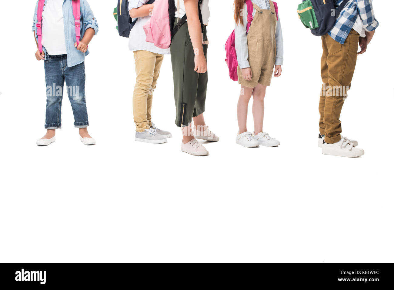 cropped shot of multiethnic children with backpacks standing together ...