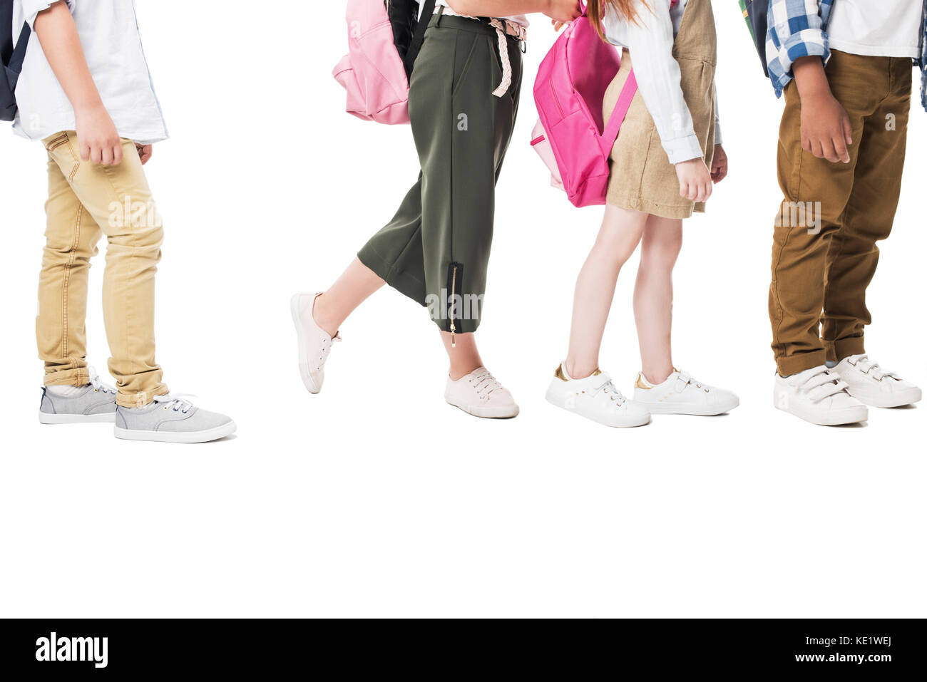 cropped shot of multiethnic children with backpacks standing together ...