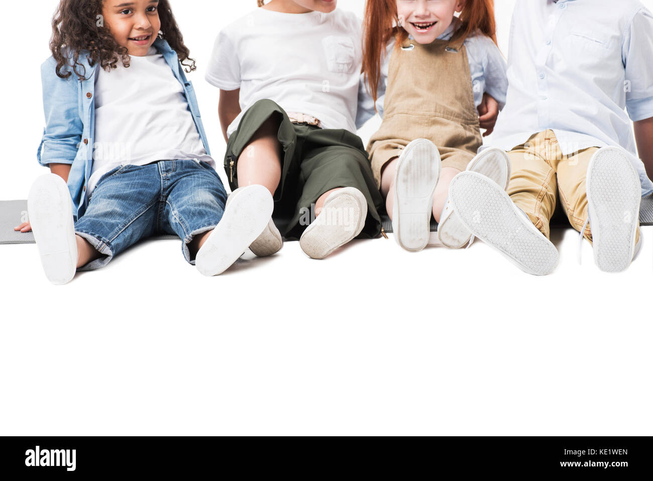 happy multiethnic children sitting together isolated on white Stock ...