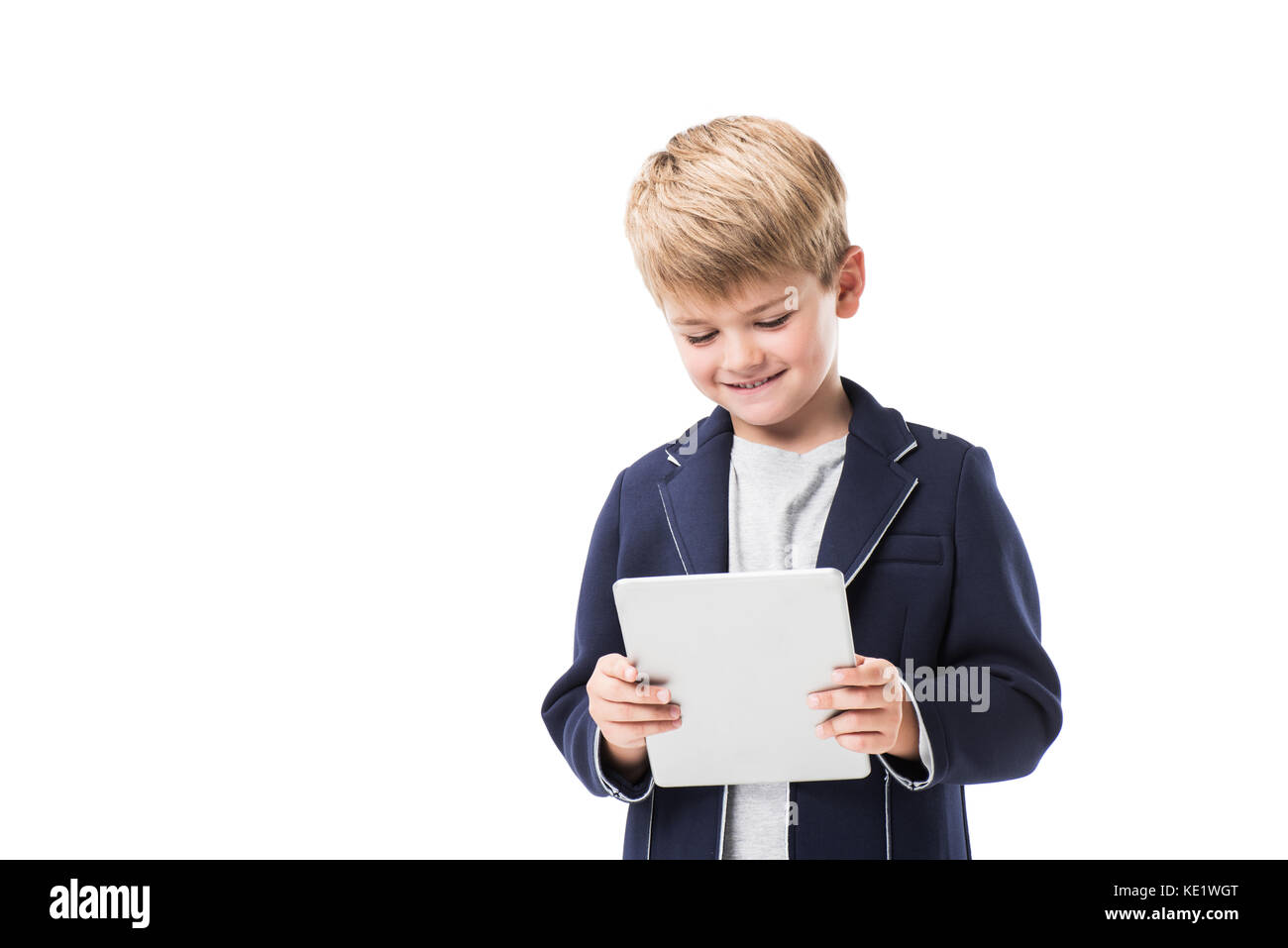 cute smiling boy using digital tablet isolated on white Stock Photo - Alamy