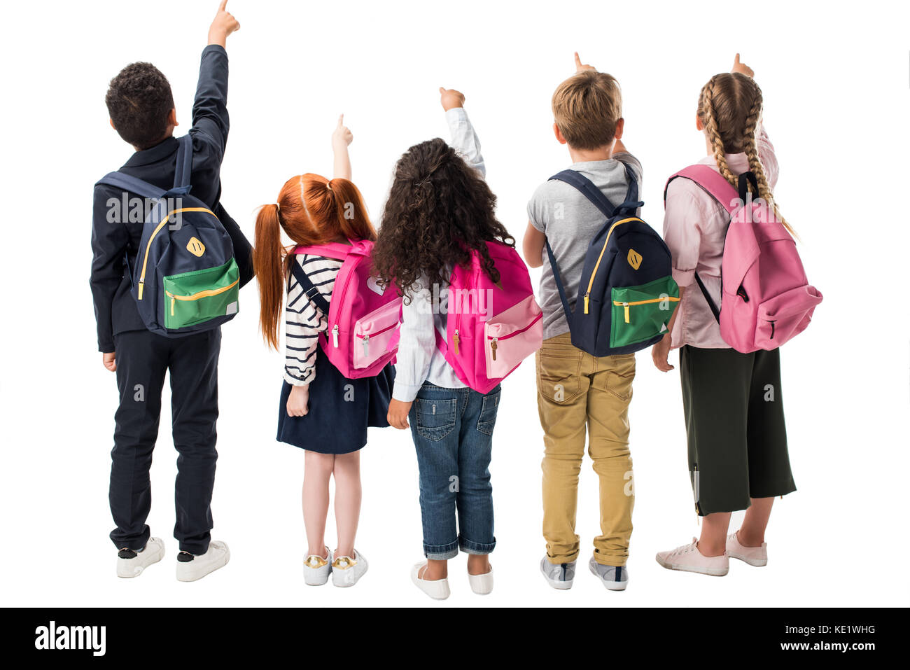 back view of multiethnic children with backpacks pointing at copy space ...