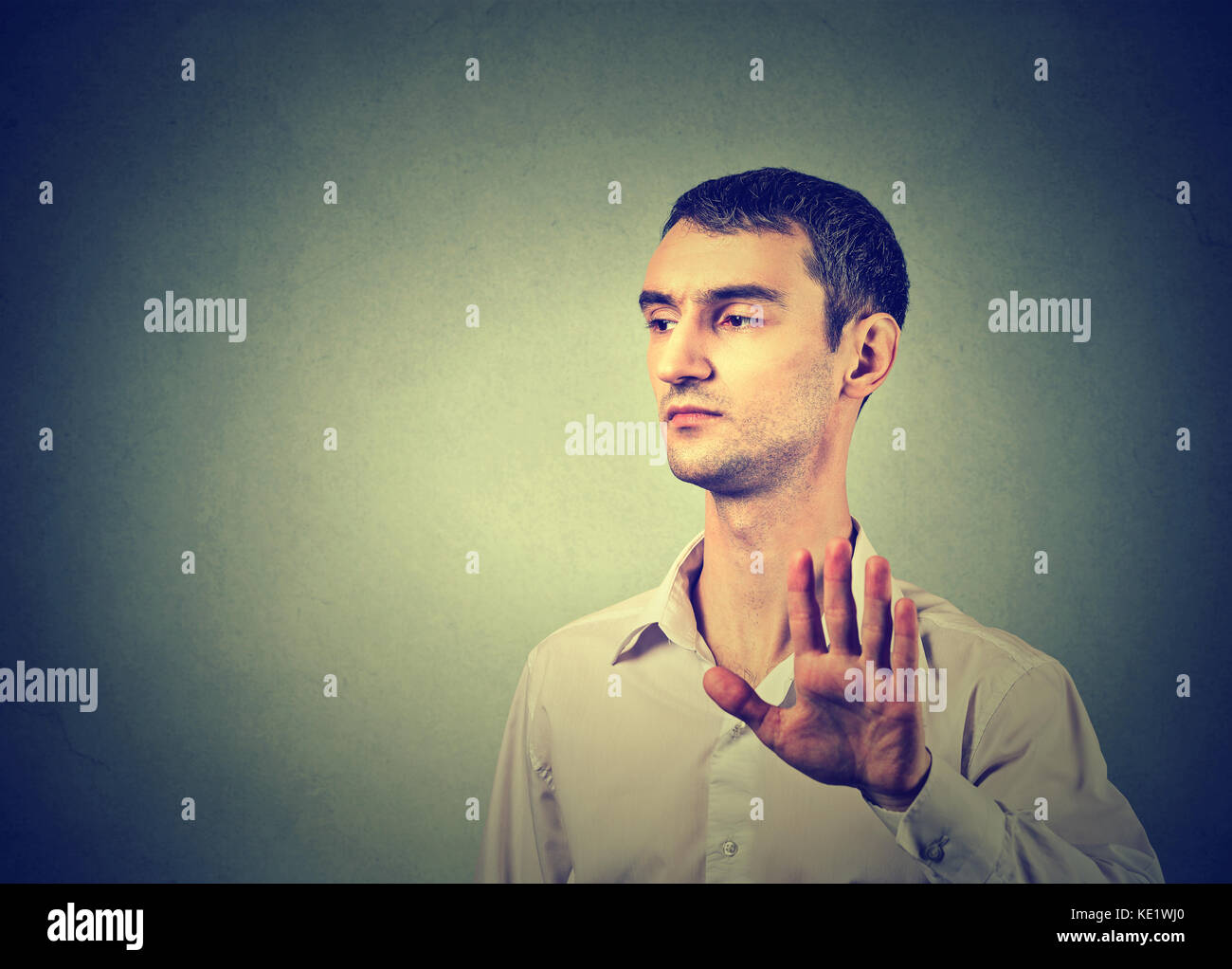 Young annoyed angry man with bad attitude giving talk to hand gesture ...