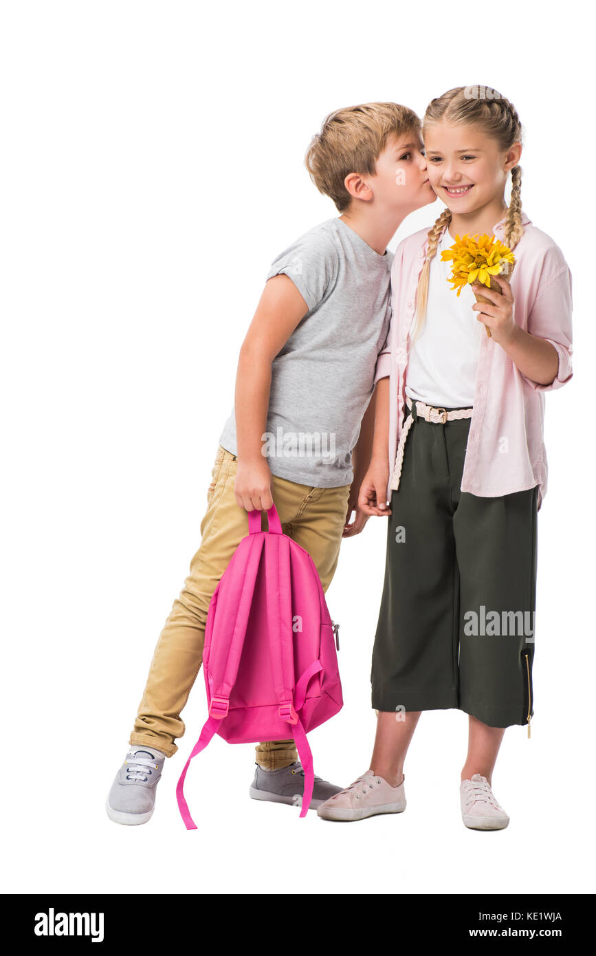 cute little boy holding pink backpack and kissing happy girl holding ...