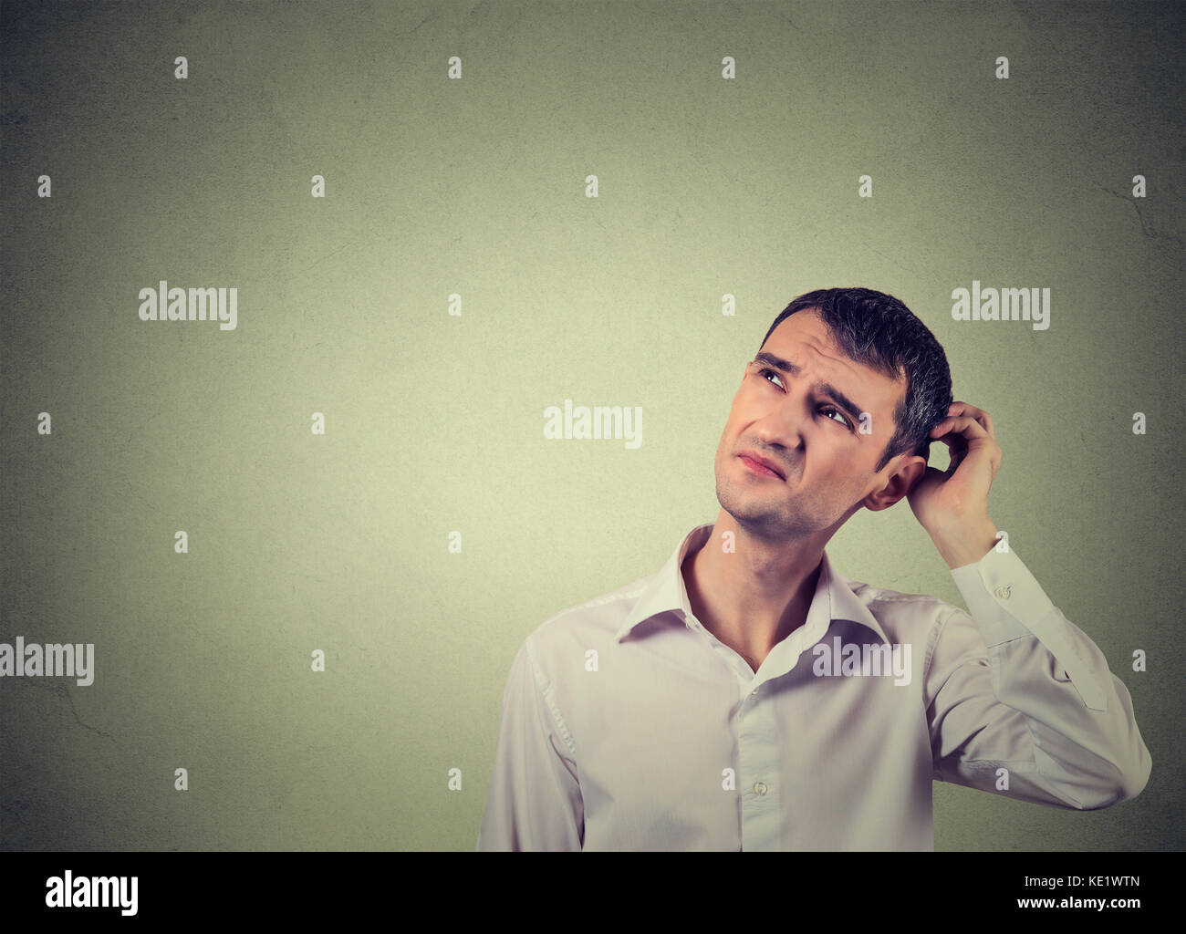 Closeup portrait man scratching head, thinking deeply about something ...