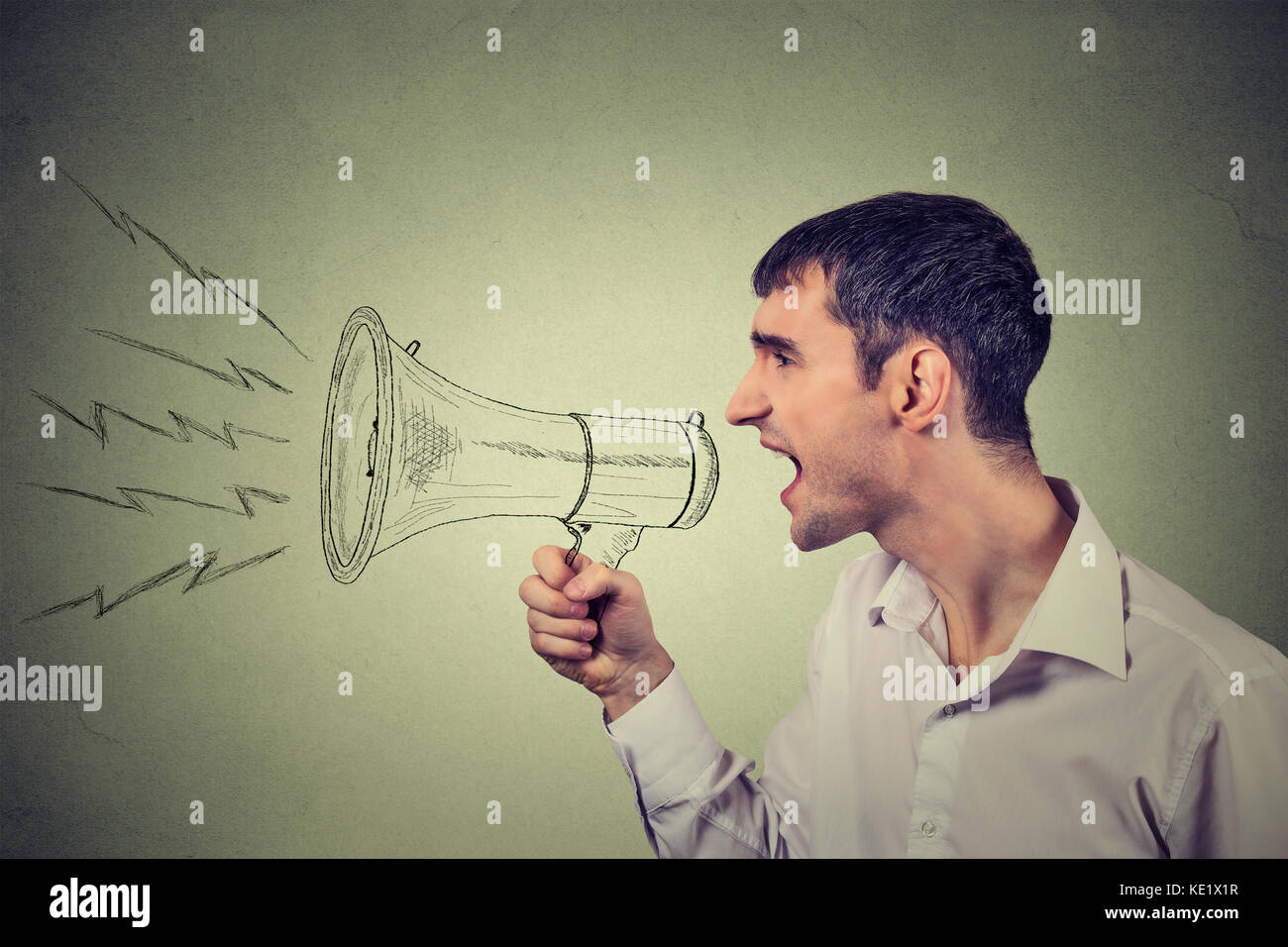 Side profile business man shouting into a megaphone isolated on gray ...