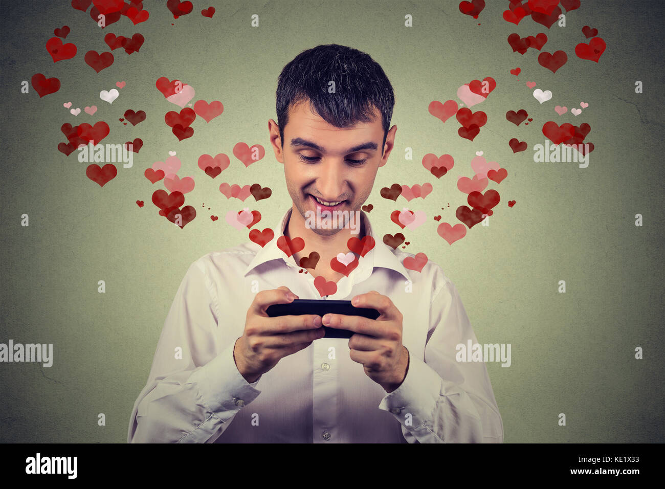 Portrait young handsome happy man sending receiving love sms text ...