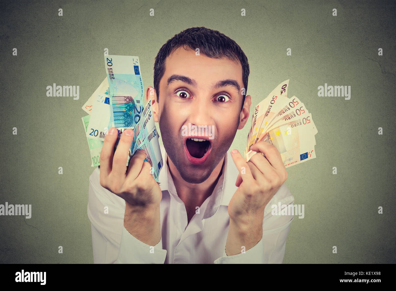 Portrait happy young man with money euro banknotes ecstatic celebrates ...
