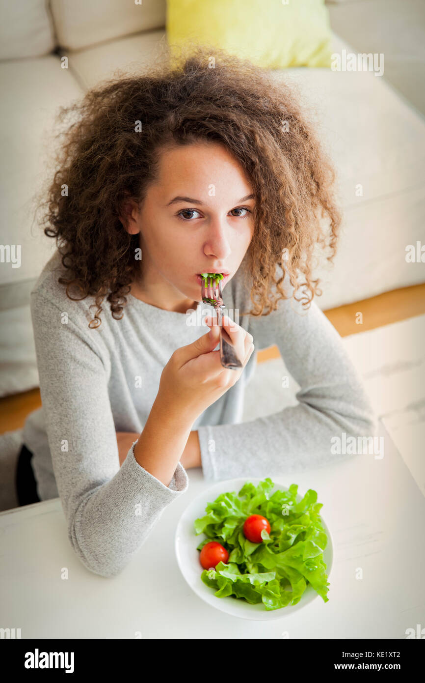 Teenager girl eating salad isolated hi-res stock photography and images ...