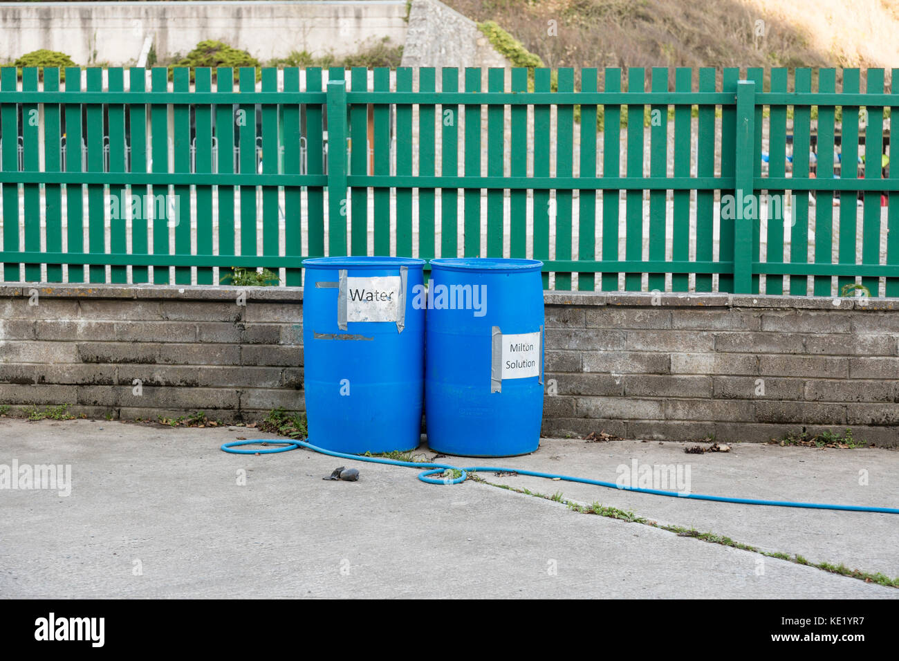 blue plastic water barrels outside Stock Photo - Alamy