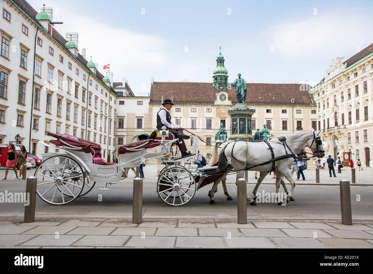 VIENNA, AUSTRIA - AUGUST 28: Tourists in a horse-drawn carriage called ...