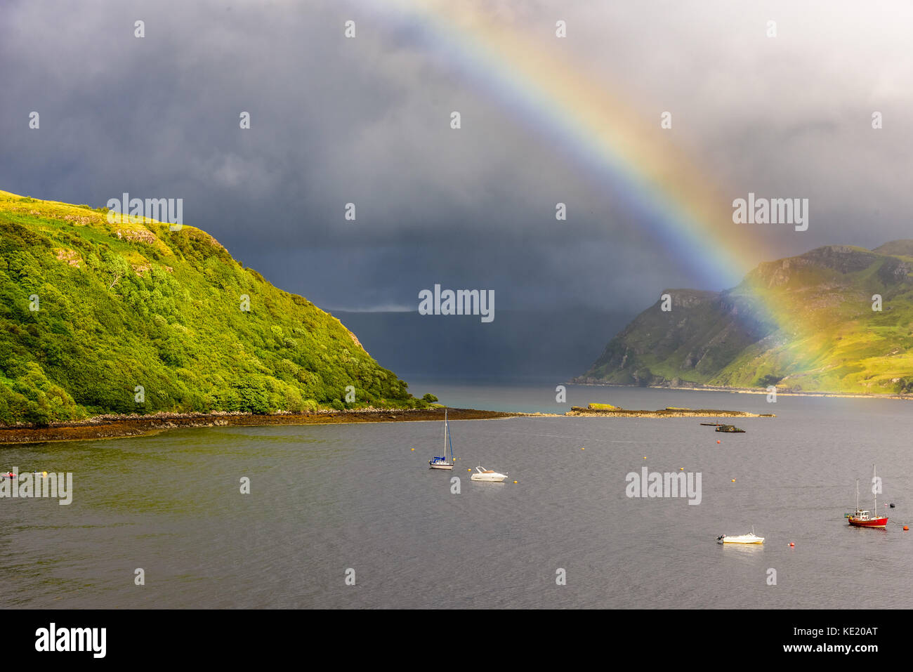 A rainbow on the Portree Bay in the Isle of Skye in Scotland Stock ...