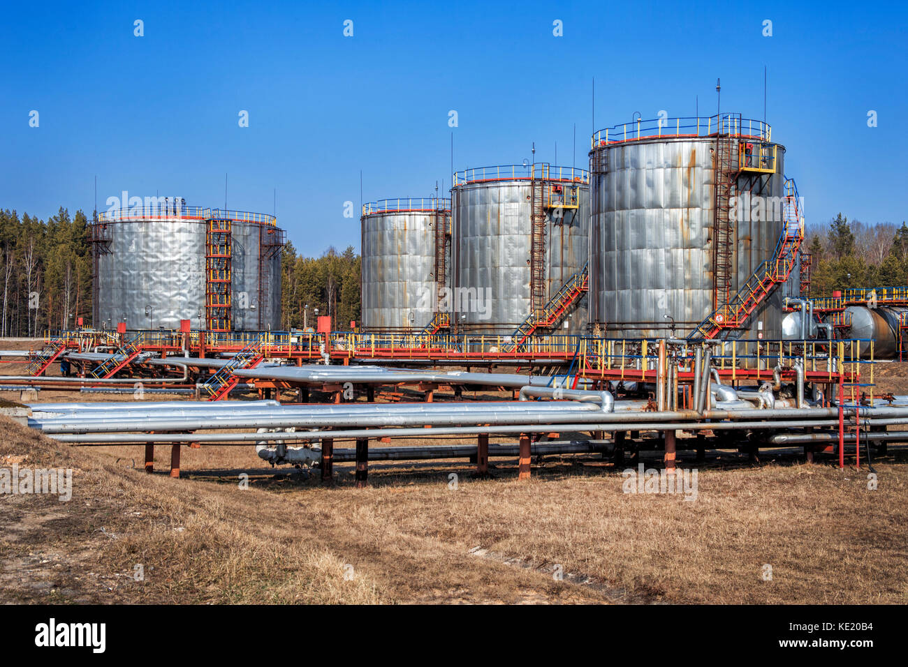 Large oil tank in industrial plant at twilight Stock Photo - Alamy