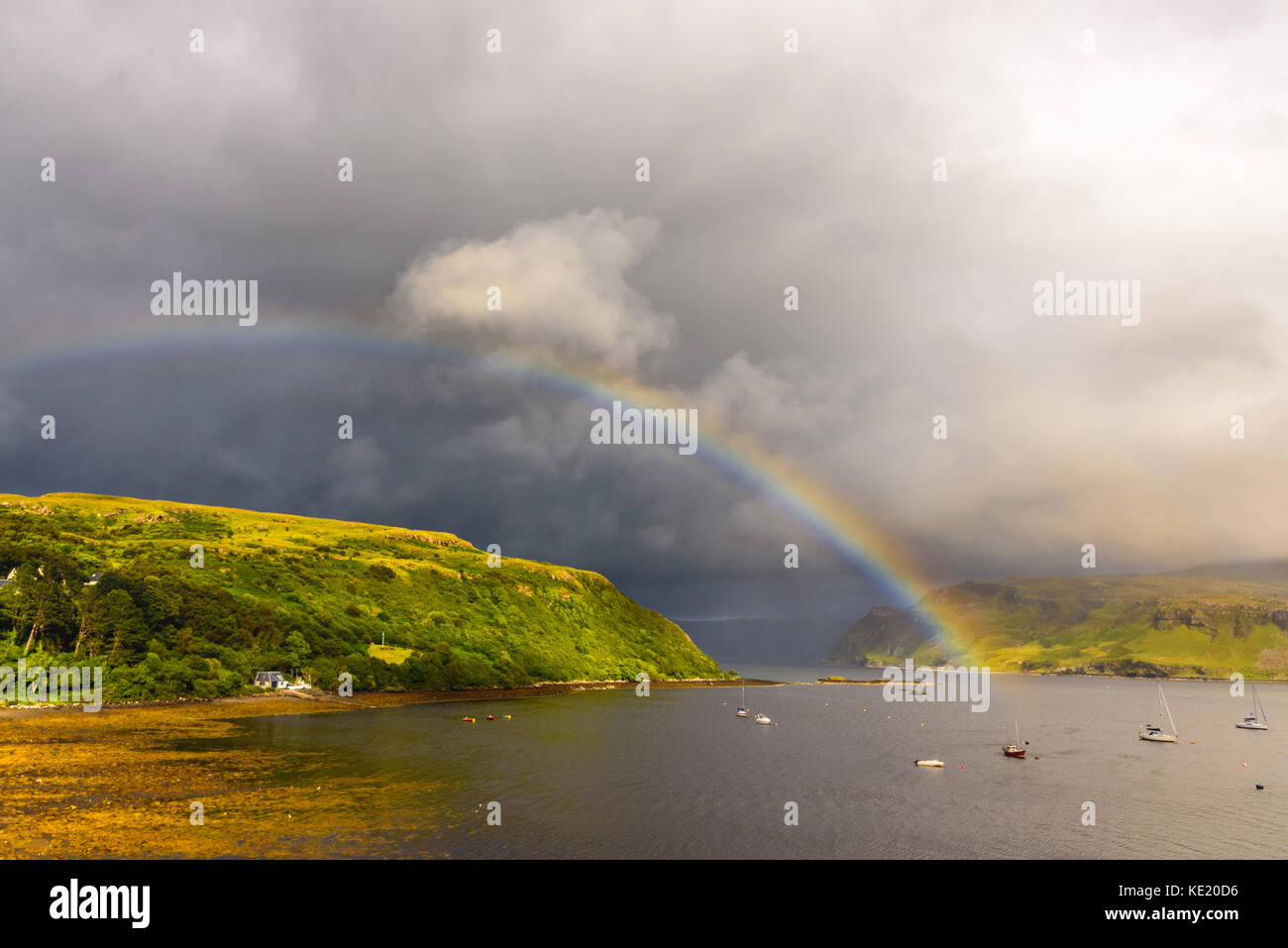 A rainbow on the Portree Bay in the Isle of Skye in Scotland Stock ...