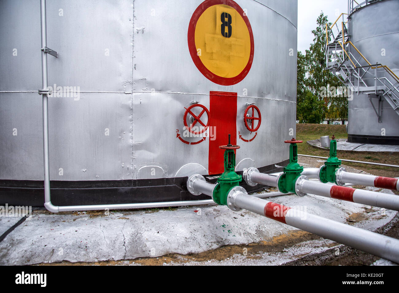 Large oil tank in industrial plant at twilight Stock Photo - Alamy