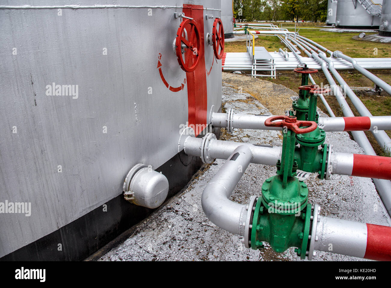 Large oil tank in industrial plant at twilight Stock Photo - Alamy