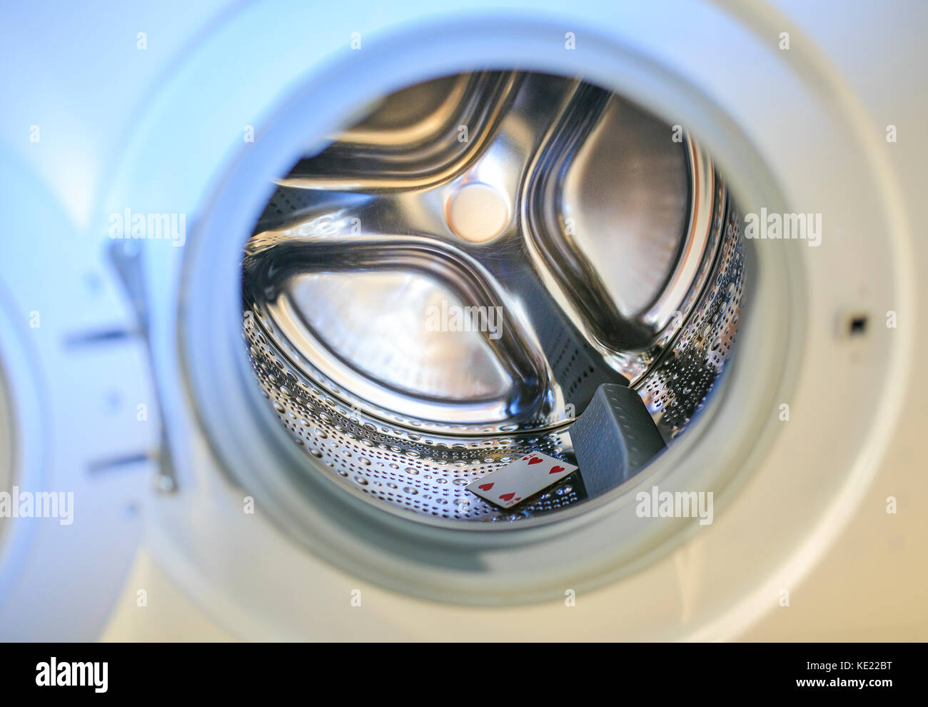 Playing card into wash machine Stock Photo - Alamy