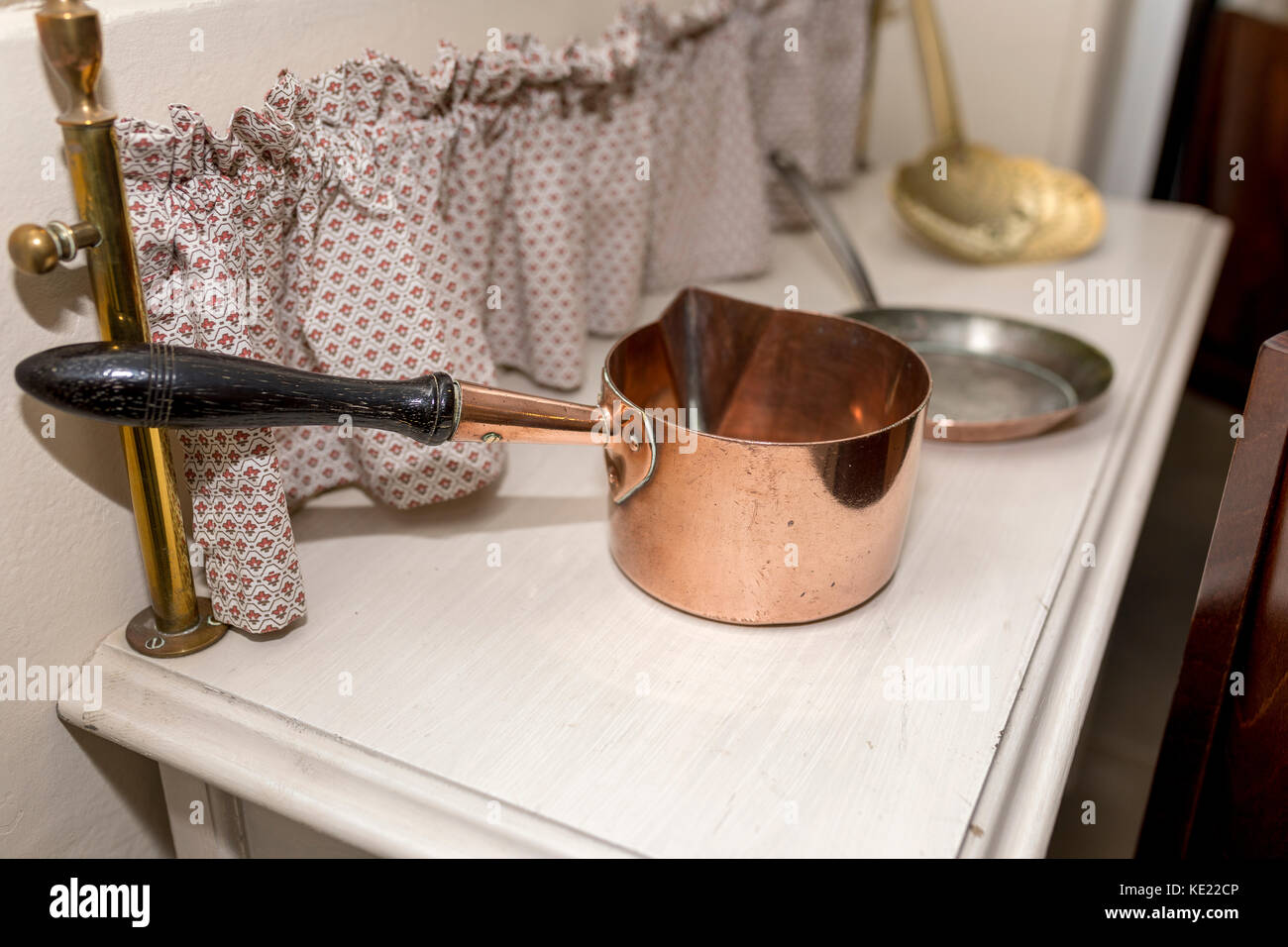 Victorian copper saucepan in a Victorian kitchen setting on a white ...