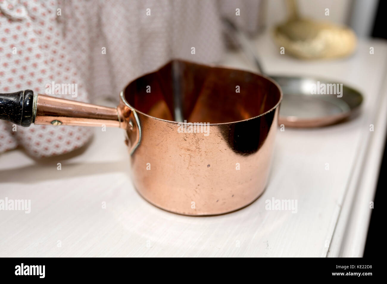 Victorian copper saucepan in a Victorian kitchen setting on a white ...