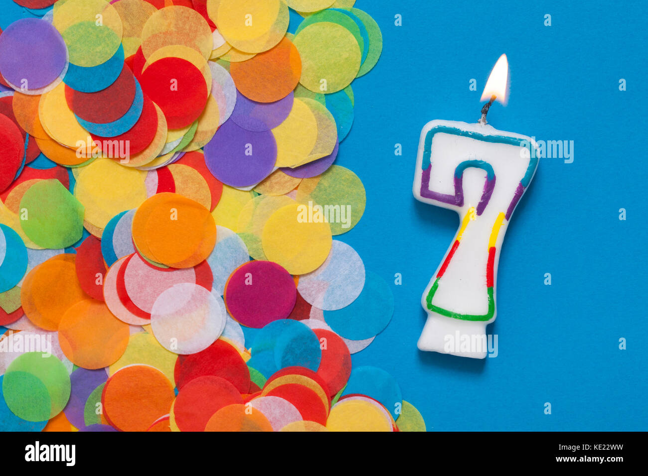 Number 7 celebration candle with party confetti Stock Photo - Alamy