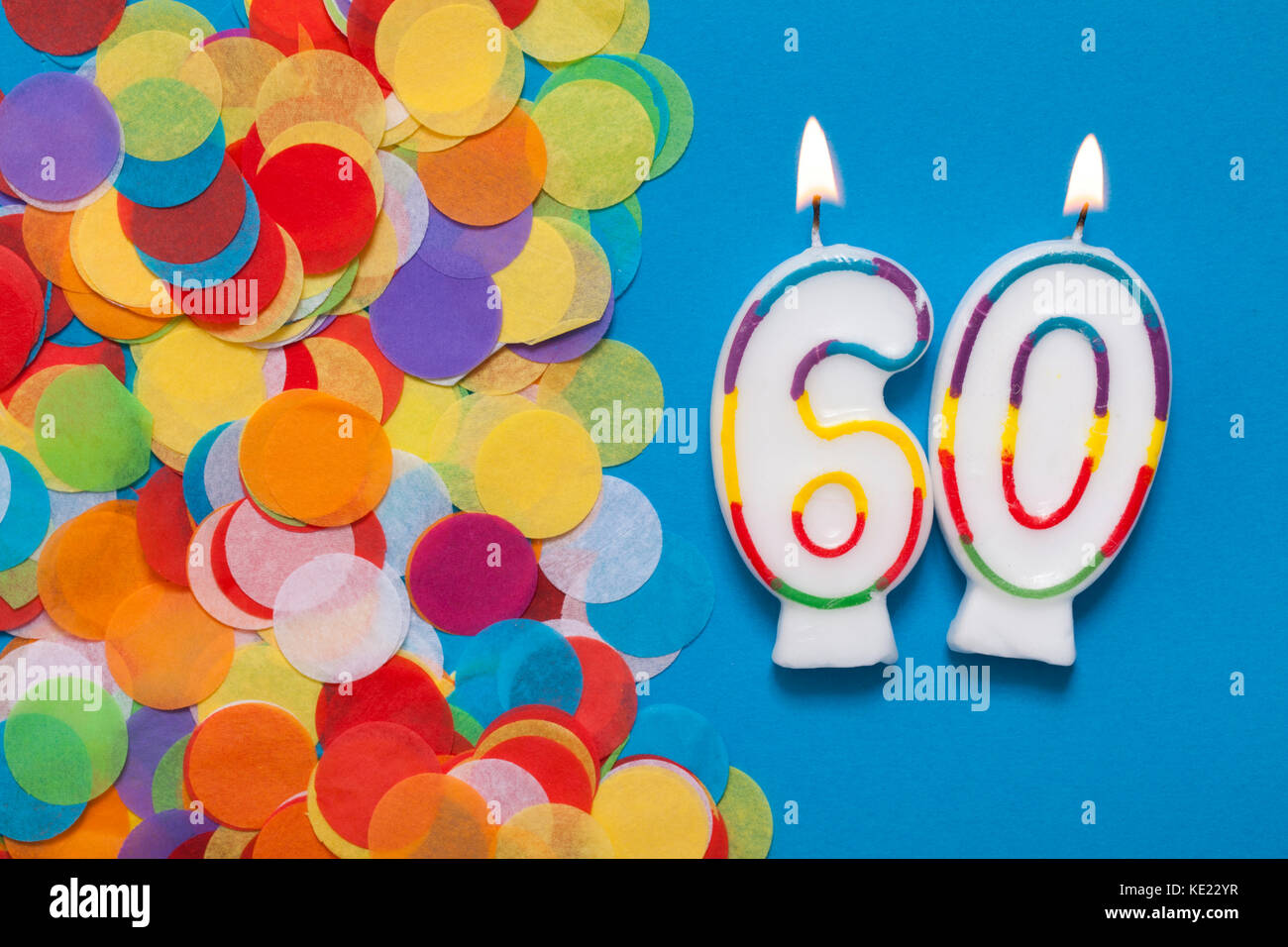 Number 60 celebration candle with party confetti Stock Photo - Alamy