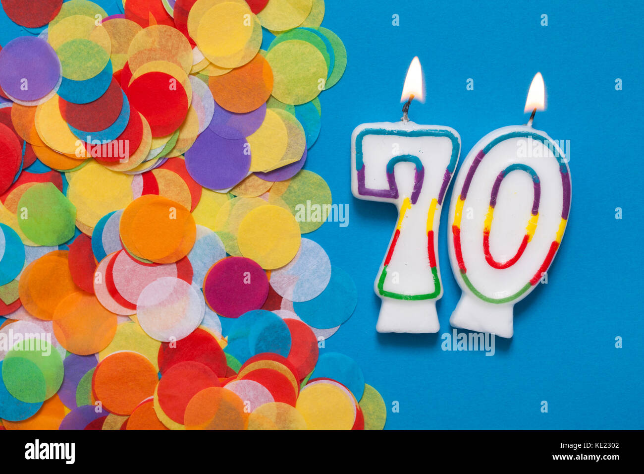 Number 70 celebration candle with party confetti Stock Photo - Alamy