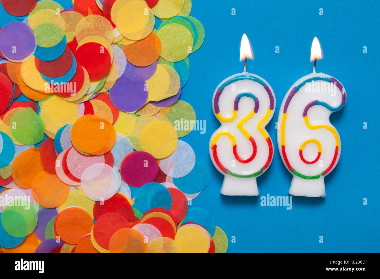 Number 36 celebration candle with party confetti Stock Photo - Alamy