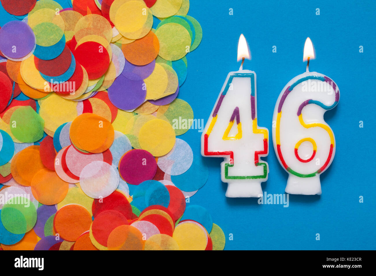 Number 46 celebration candle with party confetti Stock Photo - Alamy