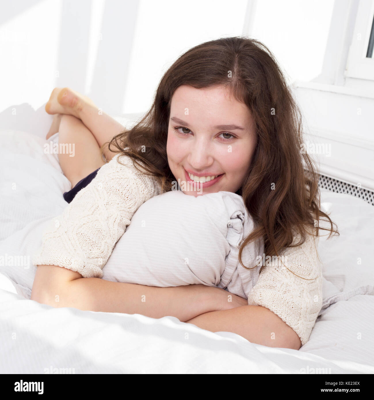 happy young woman lying on her bed Stock Photo - Alamy