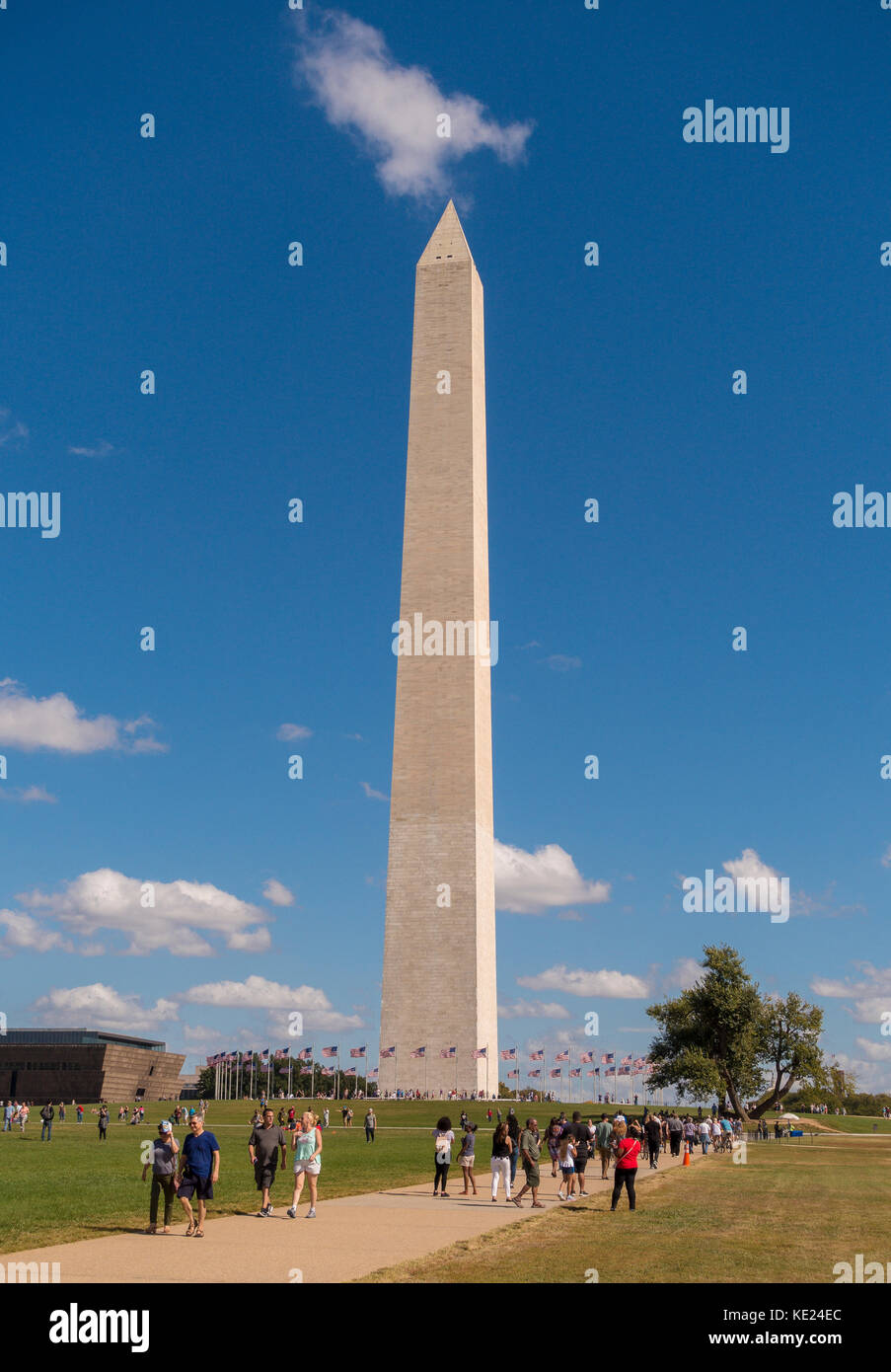 WASHINGTON, DC, USA - Washington Monument and tourists walking on path ...