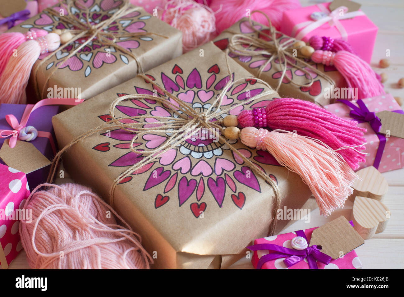 Pink tassels. Background of white wood. Women's handicrafts. The ...