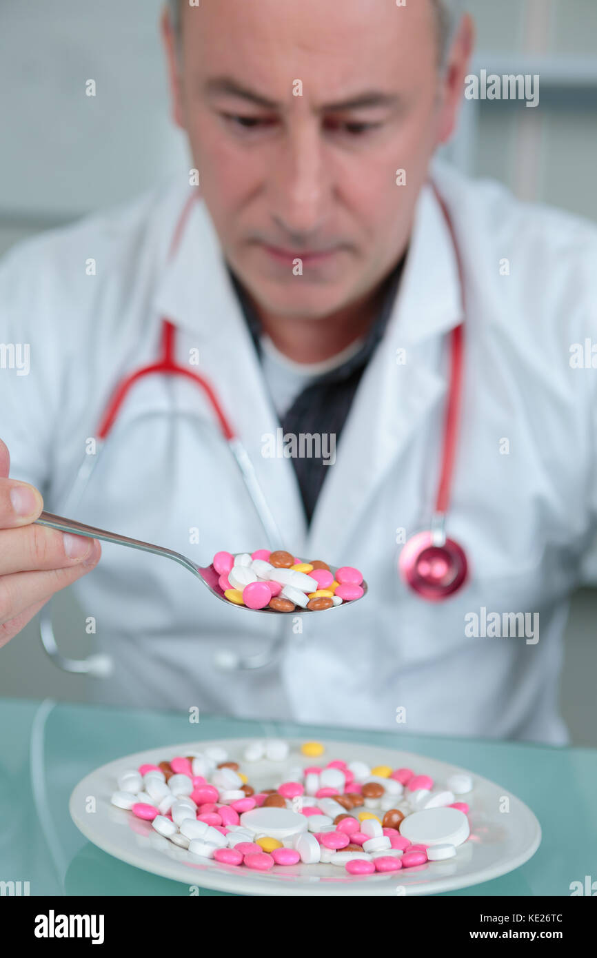 doctor with colored pills on a plate Stock Photo - Alamy