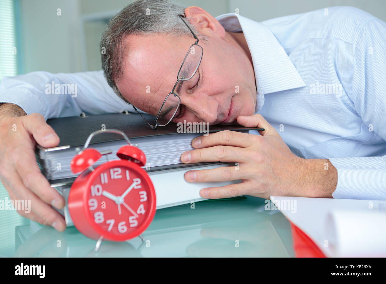 exhausted man sleeping on the desk Stock Photo - Alamy