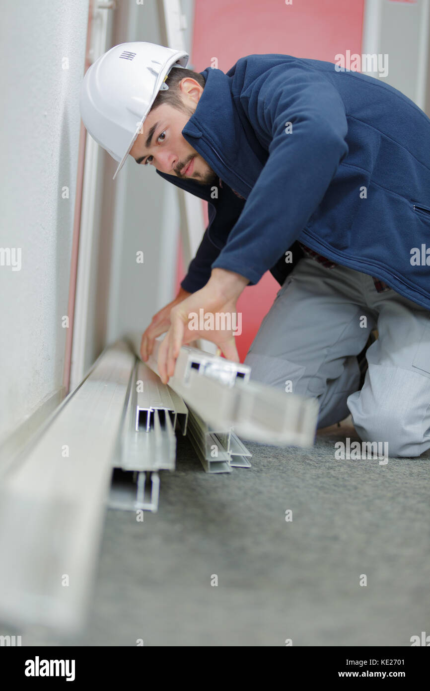 young metalworker controls some metal bars Stock Photo - Alamy