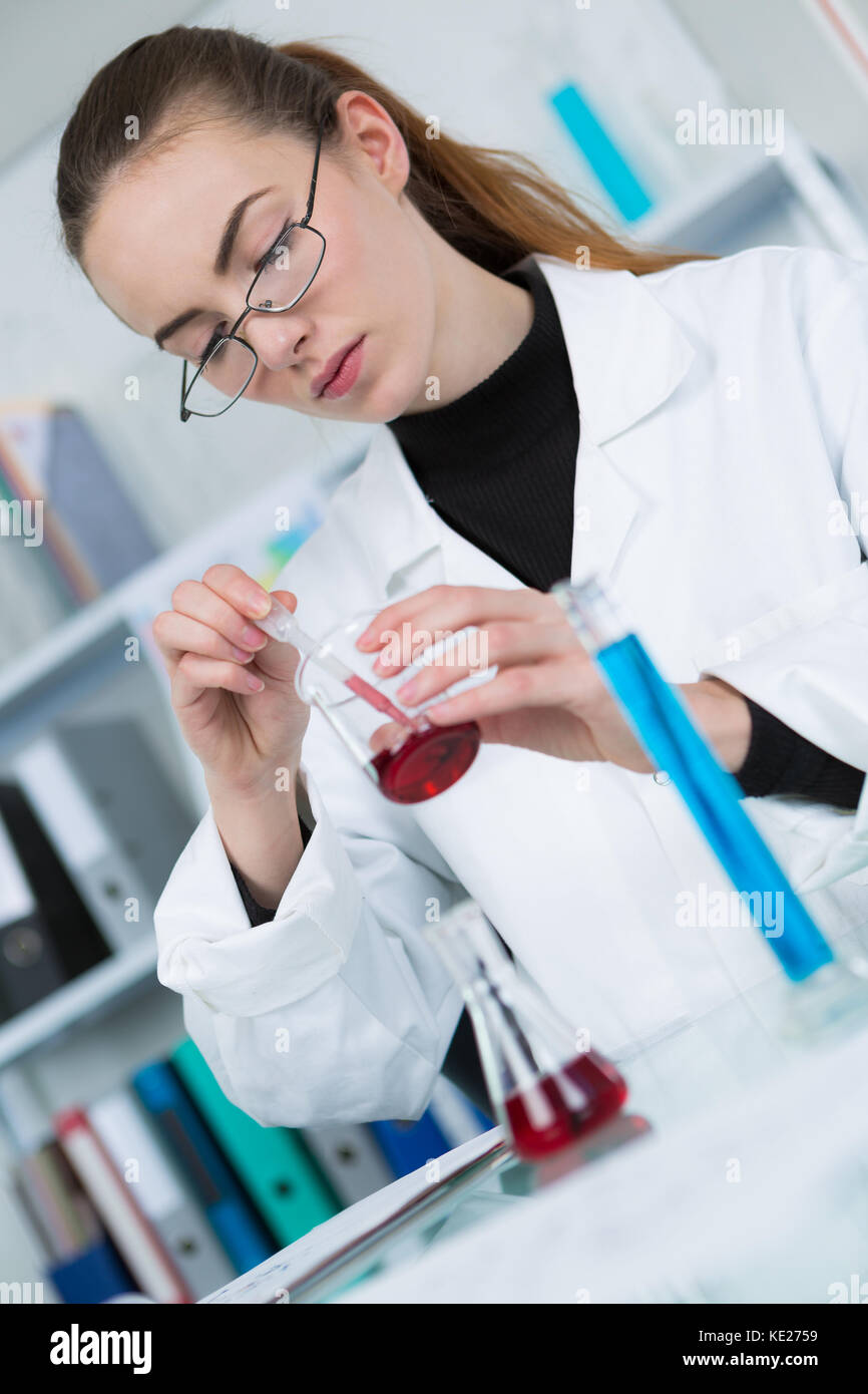 Female scientist performing experiment Stock Photo - Alamy