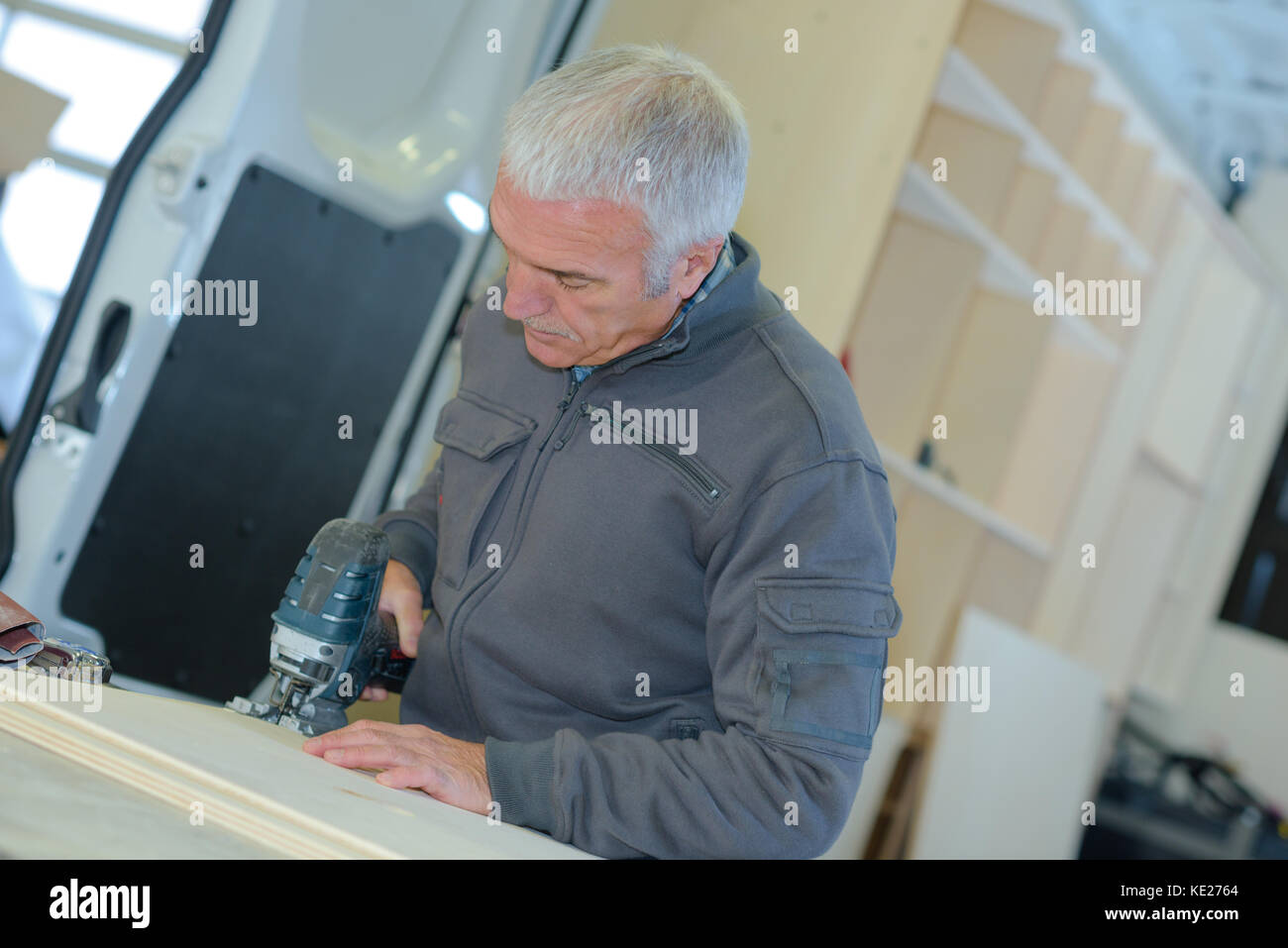 Male using power jigsaw hi-res stock photography and images - Alamy