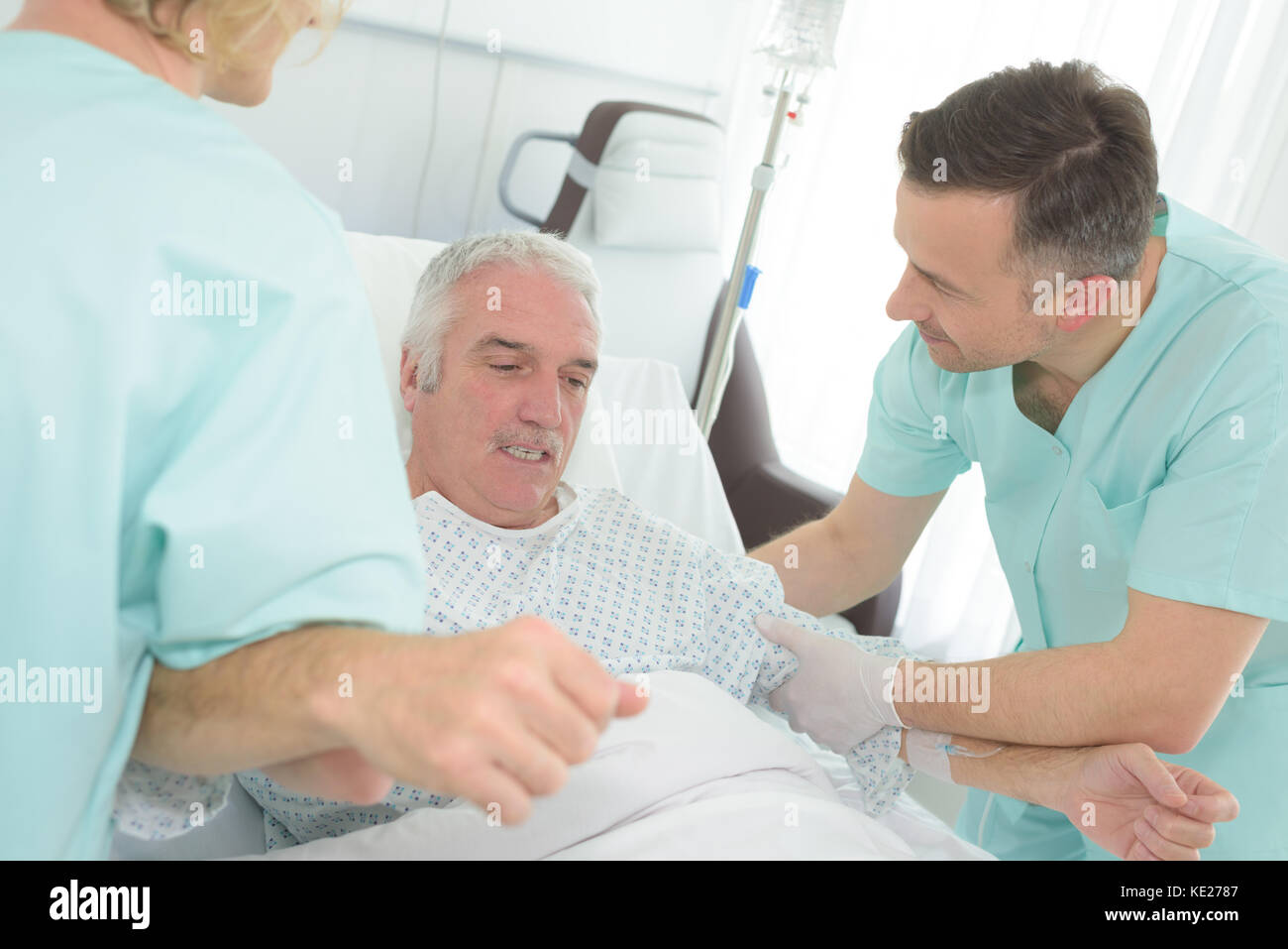 angry psychiatric patient helded by two nurses Stock Photo - Alamy