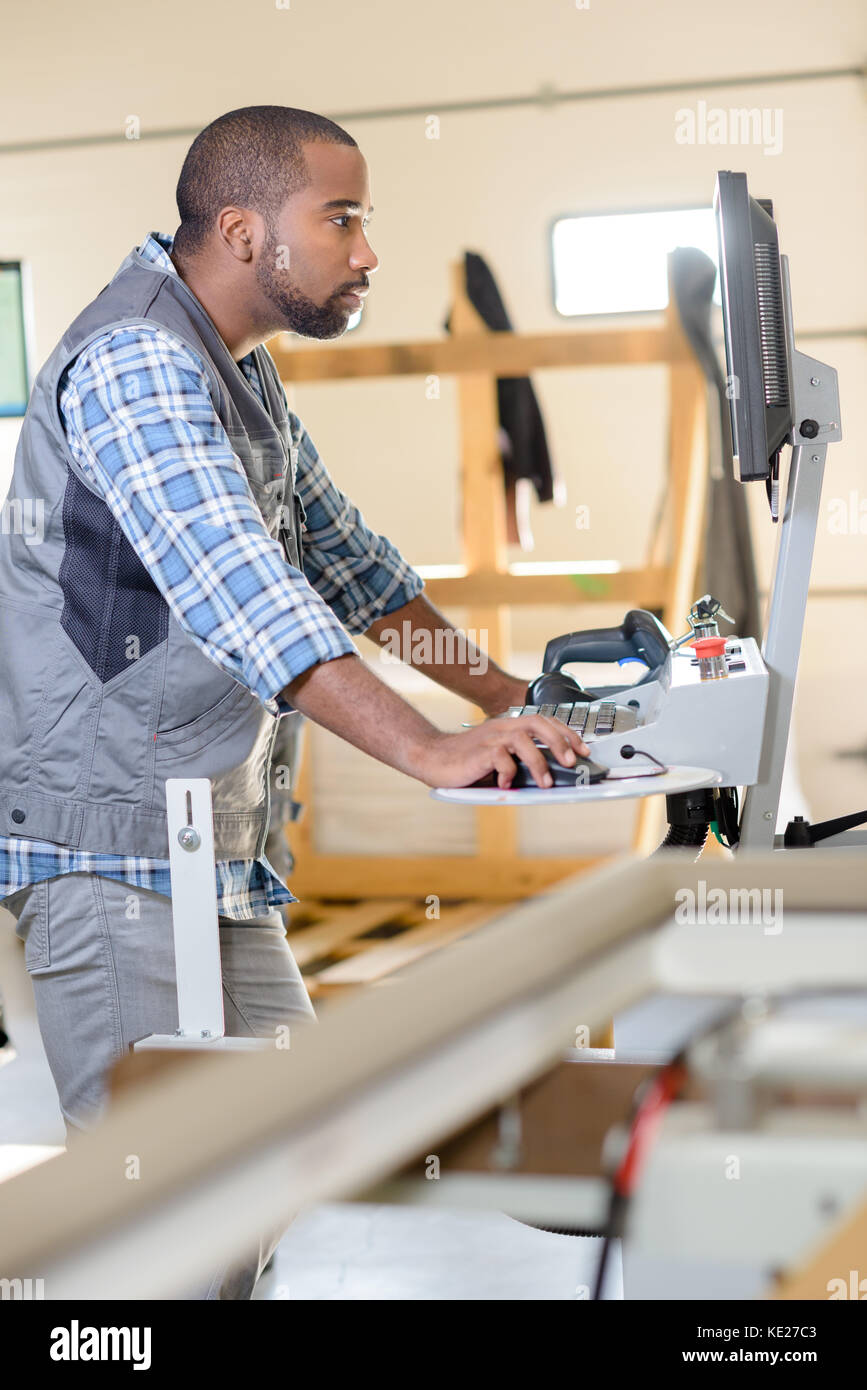 Tradesman using computer Stock Photo - Alamy