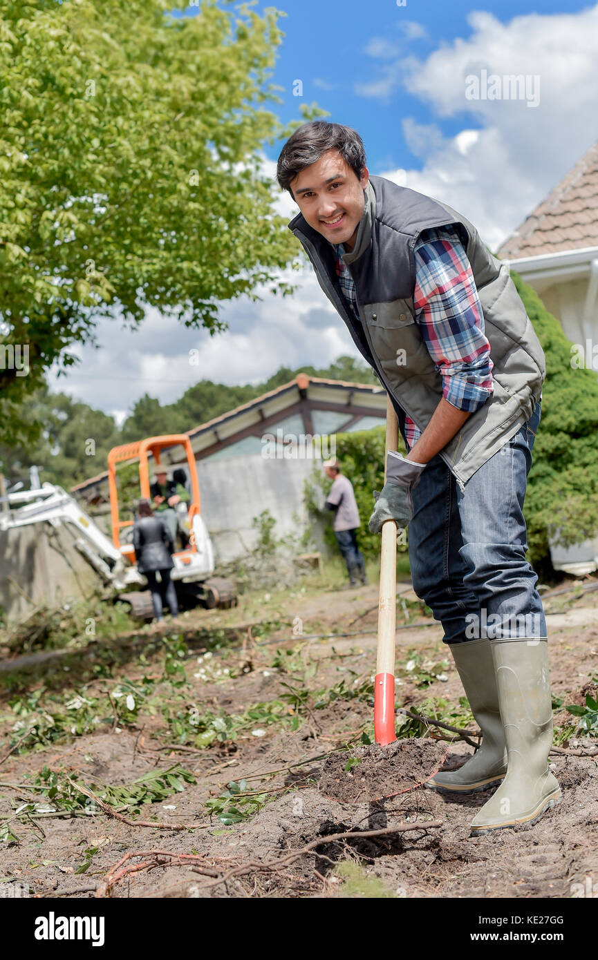 Gardener digging the ground Stock Photo - Alamy