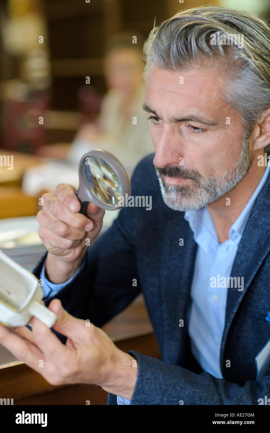 businessman using a magnifying glass Stock Photo - Alamy