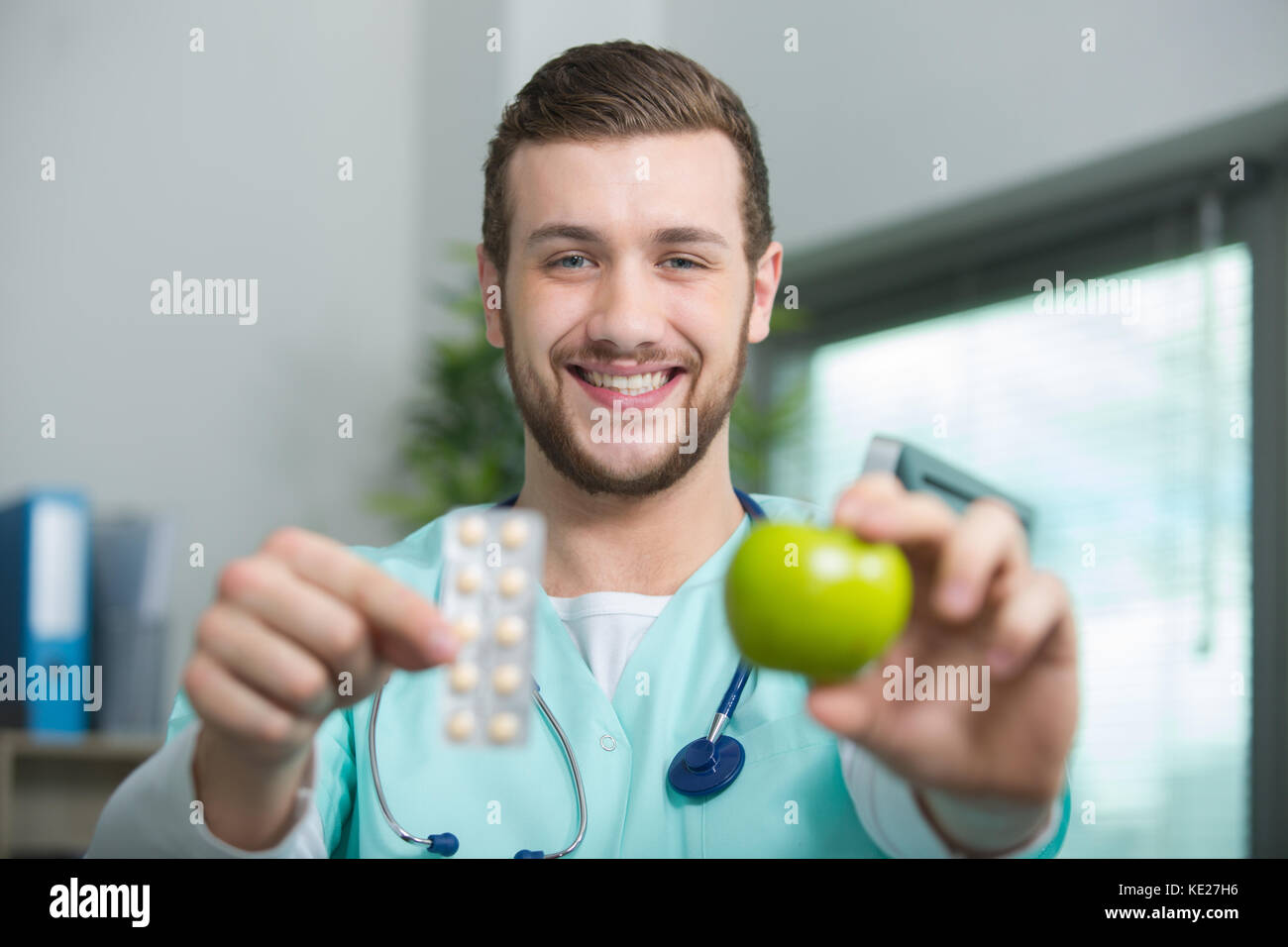 doctor with apple on a light background Stock Photo - Alamy