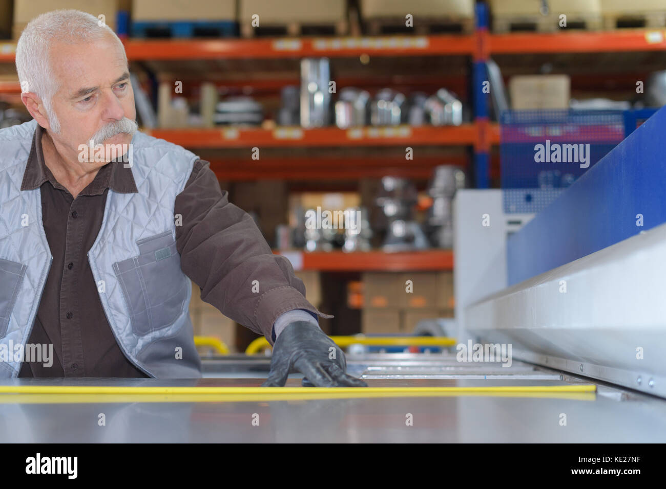 old mechanic working on factory machine Stock Photo - Alamy