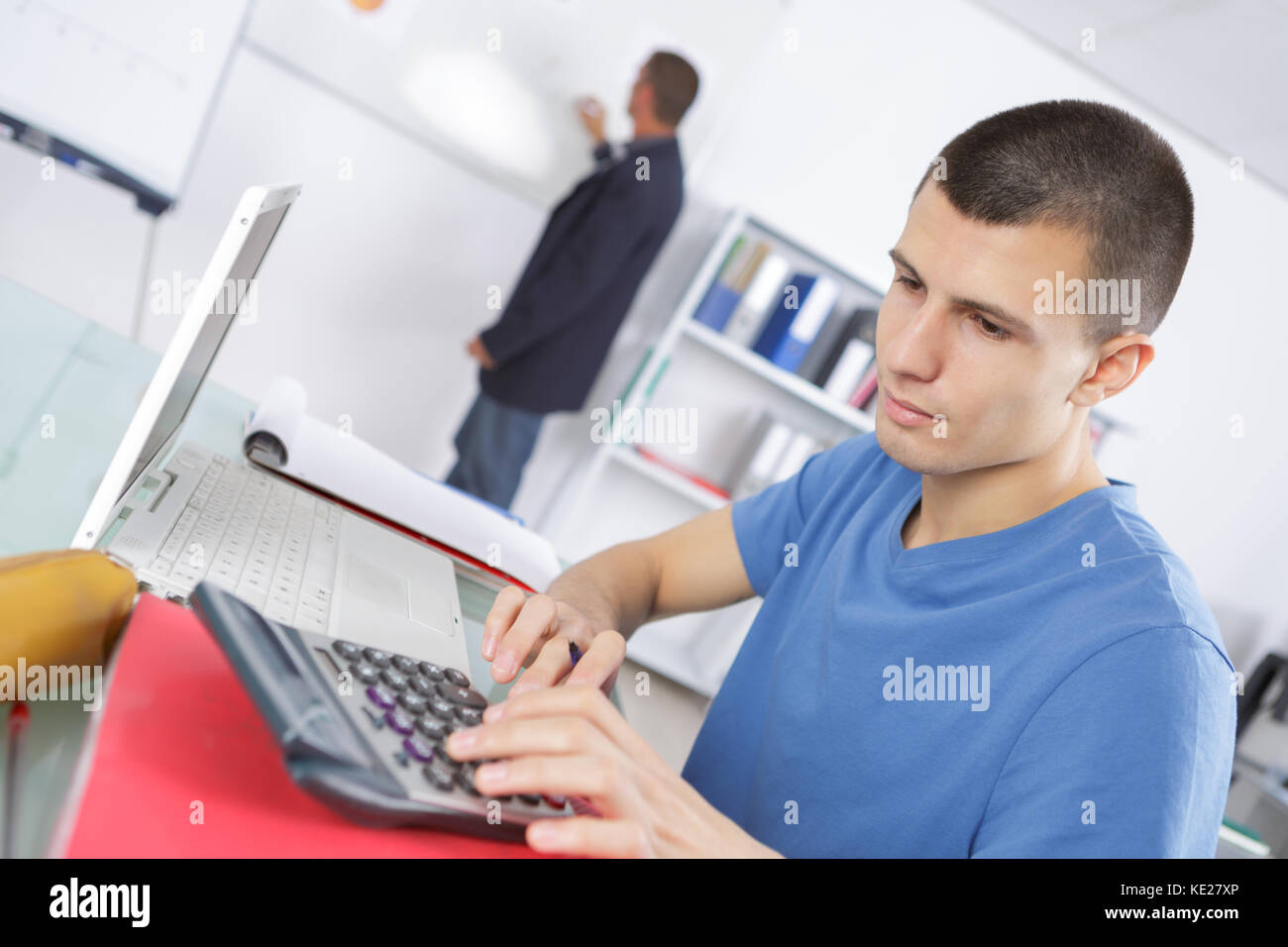 young student writing notes in the classroom Stock Photo - Alamy