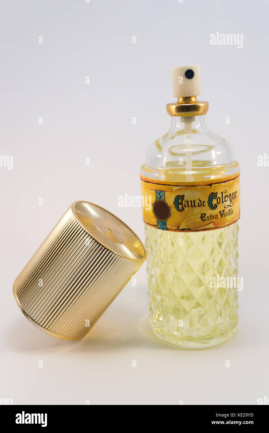 Bottle of cologne water old vintage with its golden cap on a white ...