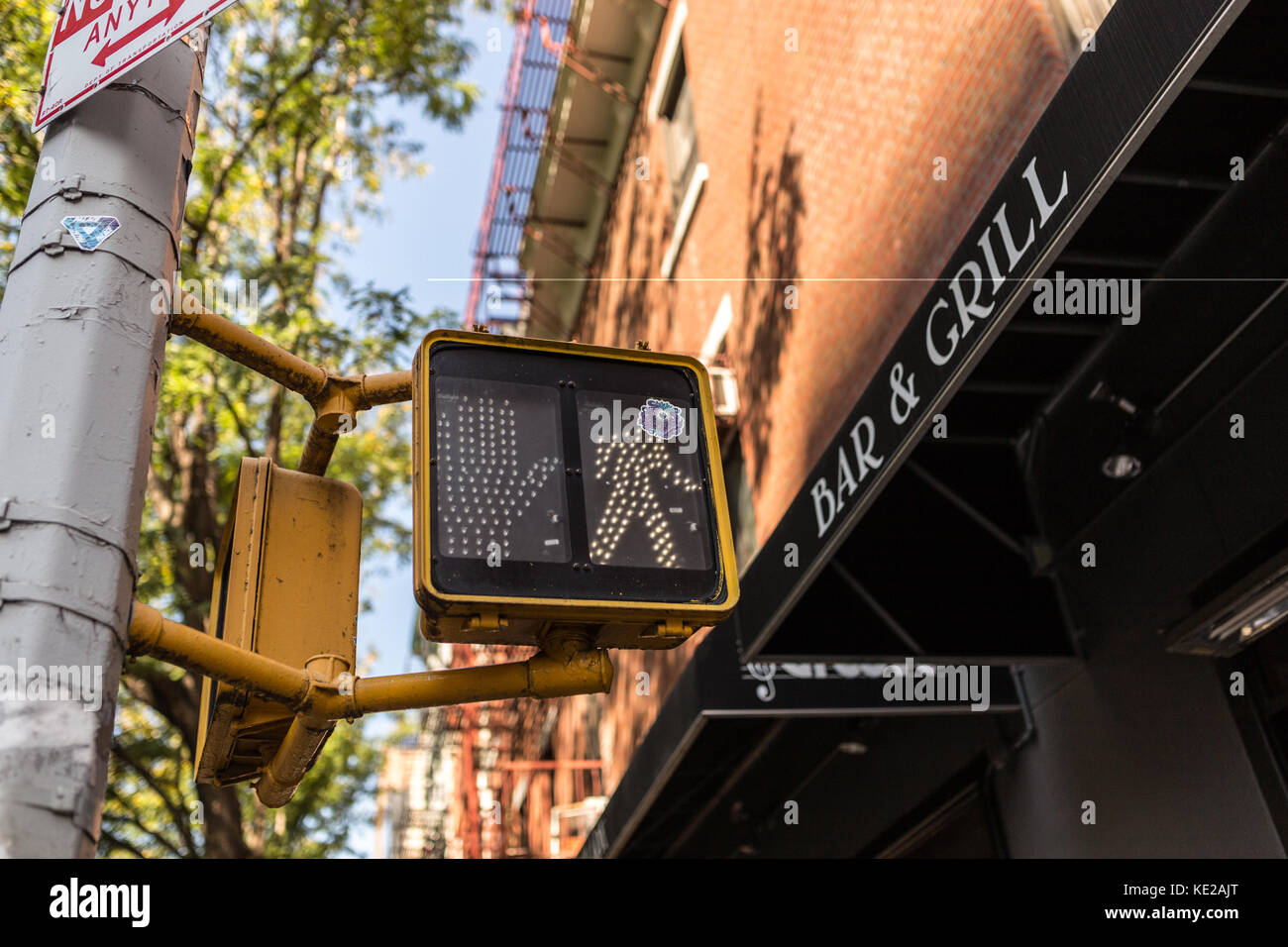 Sticker on head of pedestrian crossing 'man' in Manhattan, NY Stock ...