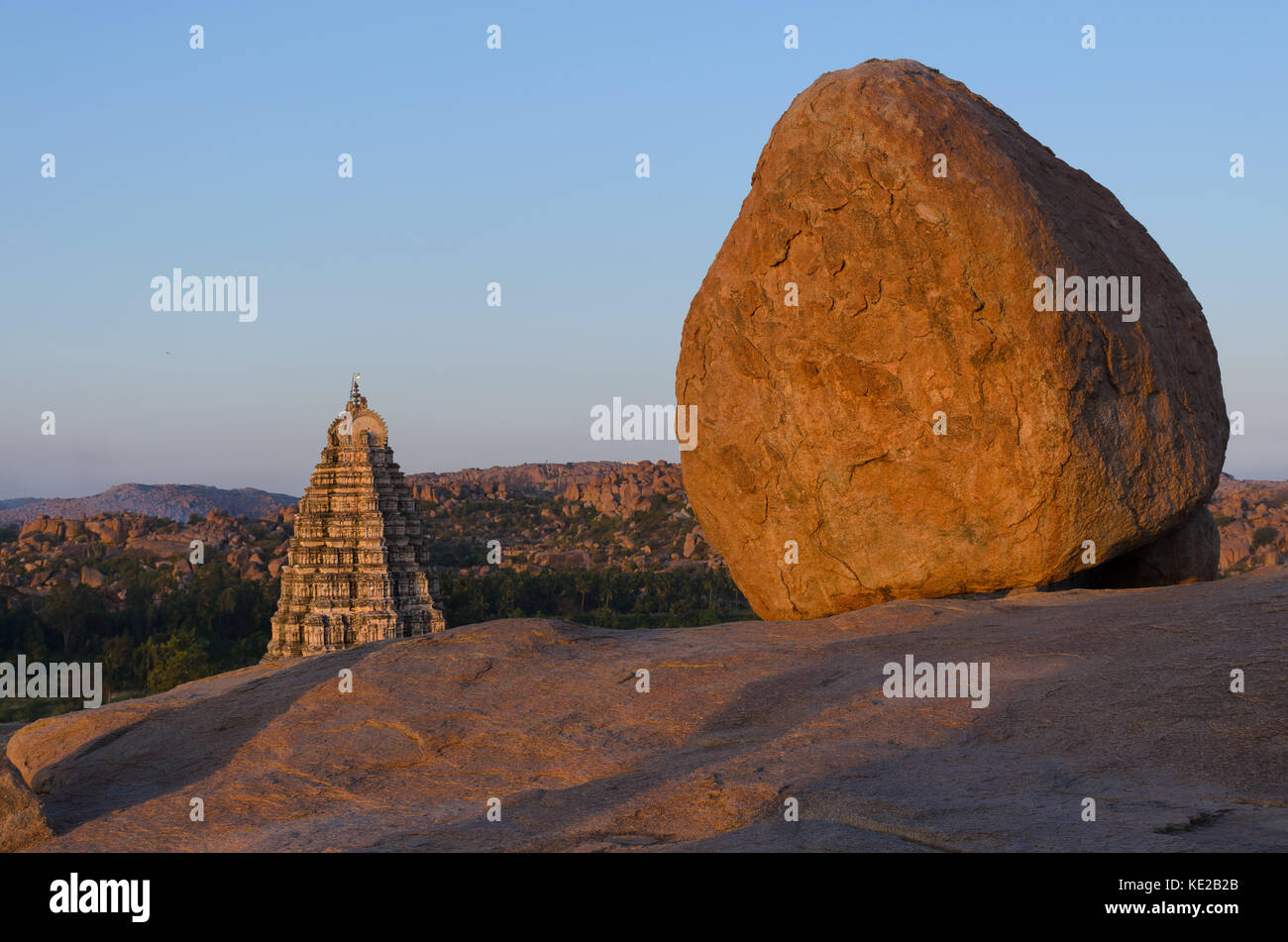 Rock boulder and the pyramid of Hindu temple Vijayanagara at sunset, in ...