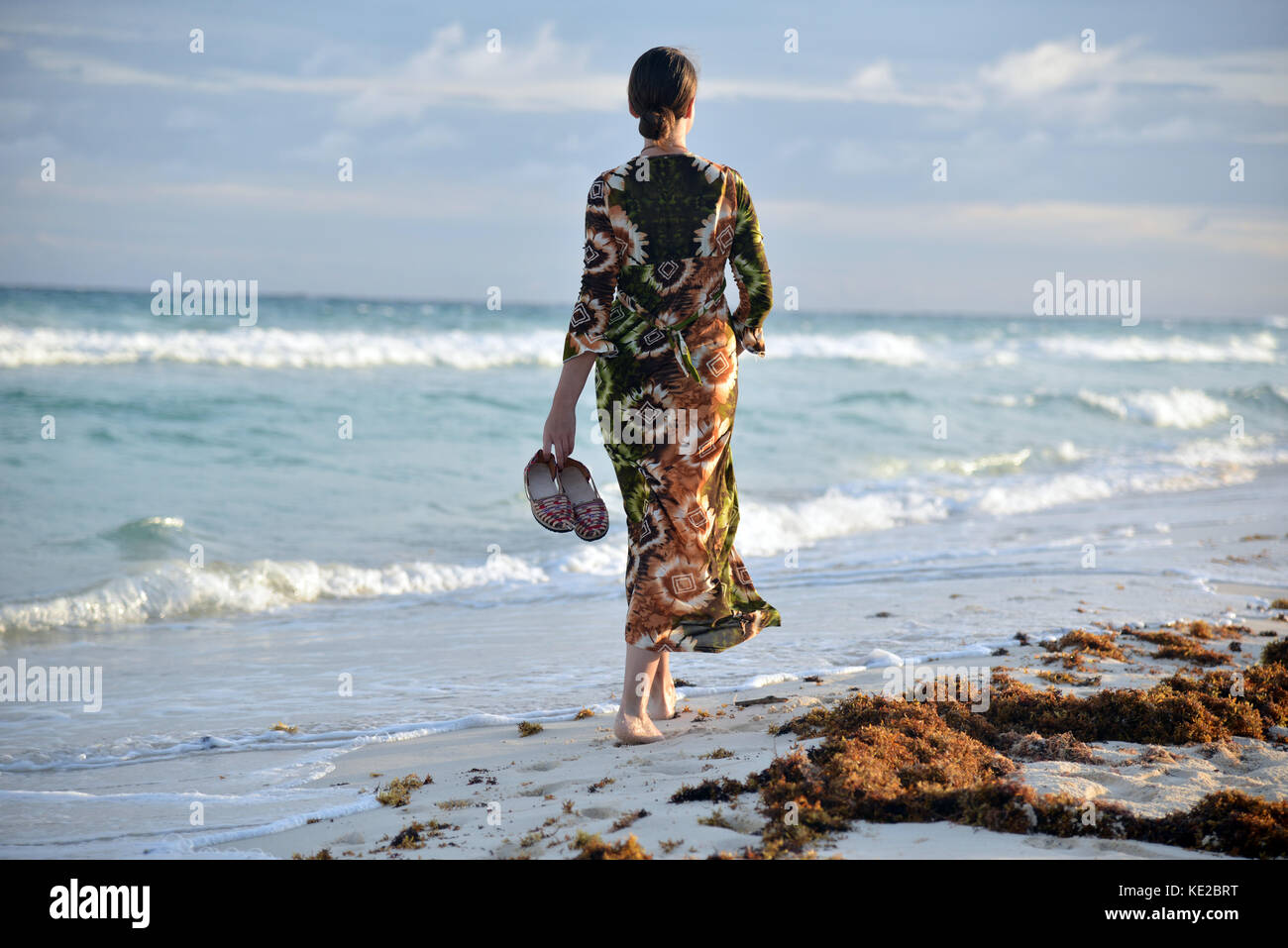 Women walking on beach in sunset Stock Photo - Alamy