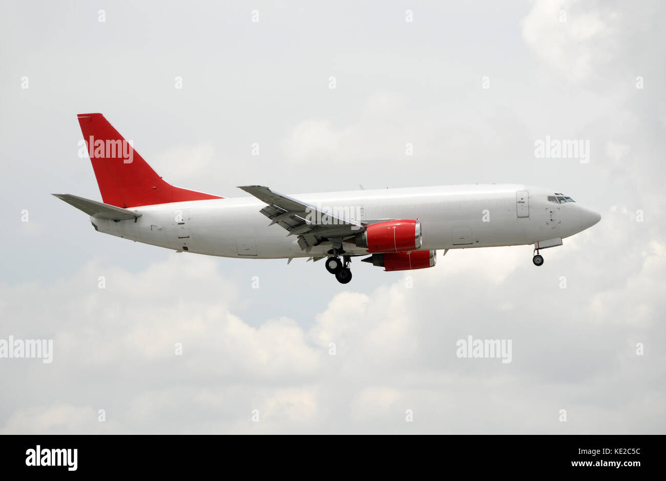 Jet airplane carrying cargo with landing gear down Stock Photo - Alamy